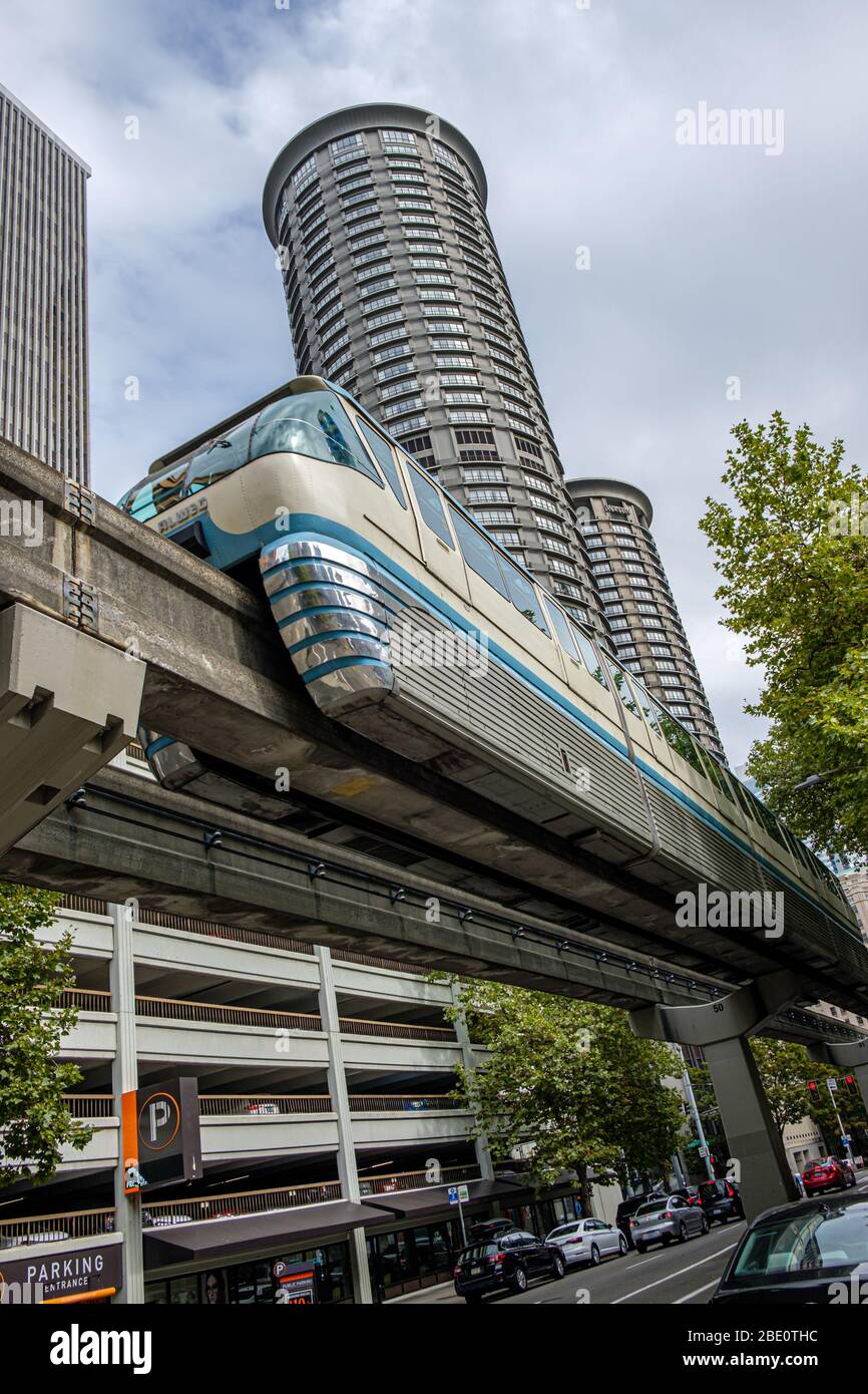 The monorail passing in front of two iconic buildings in Seattle, WA ...