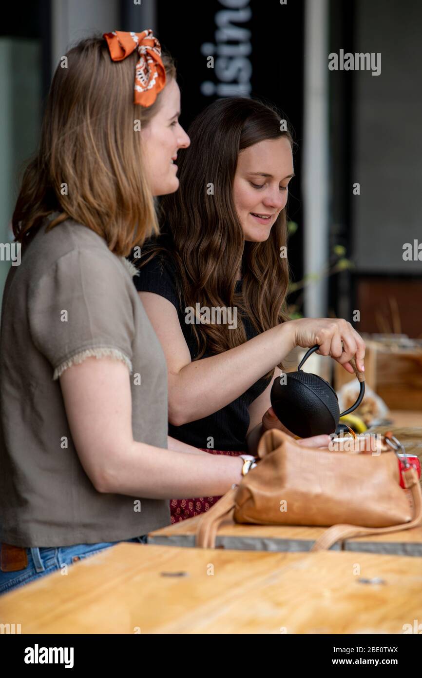 Young women connecting in a tea lounge Stock Photo - Alamy