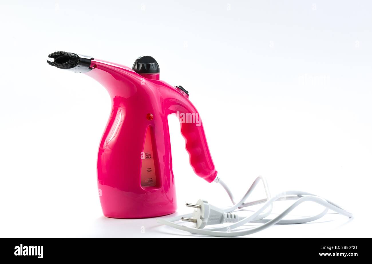 Garment steamer, pink portable iron for home isolated on white ...