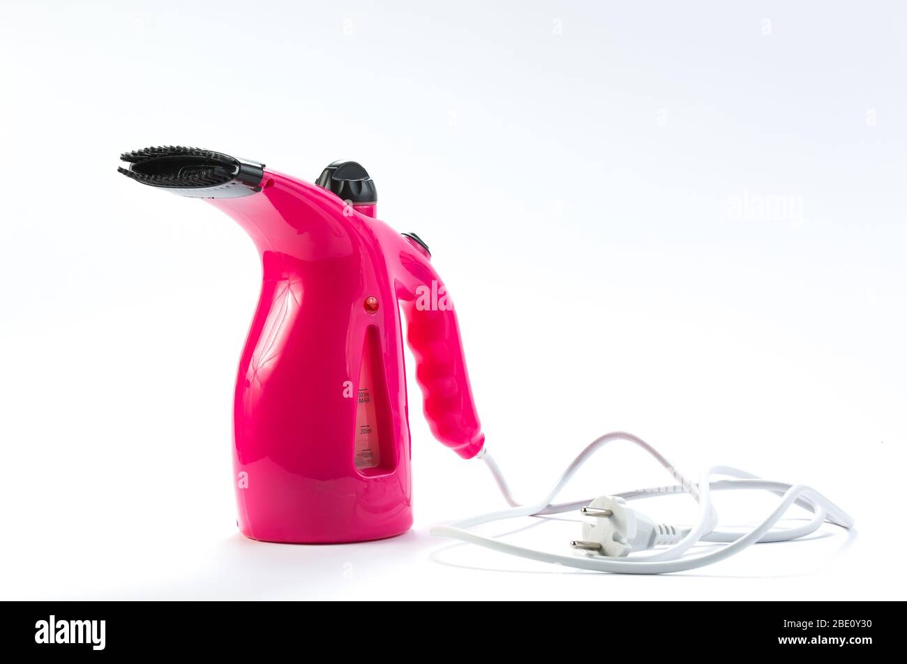 Garment steamer, pink portable iron for home isolated on white ...