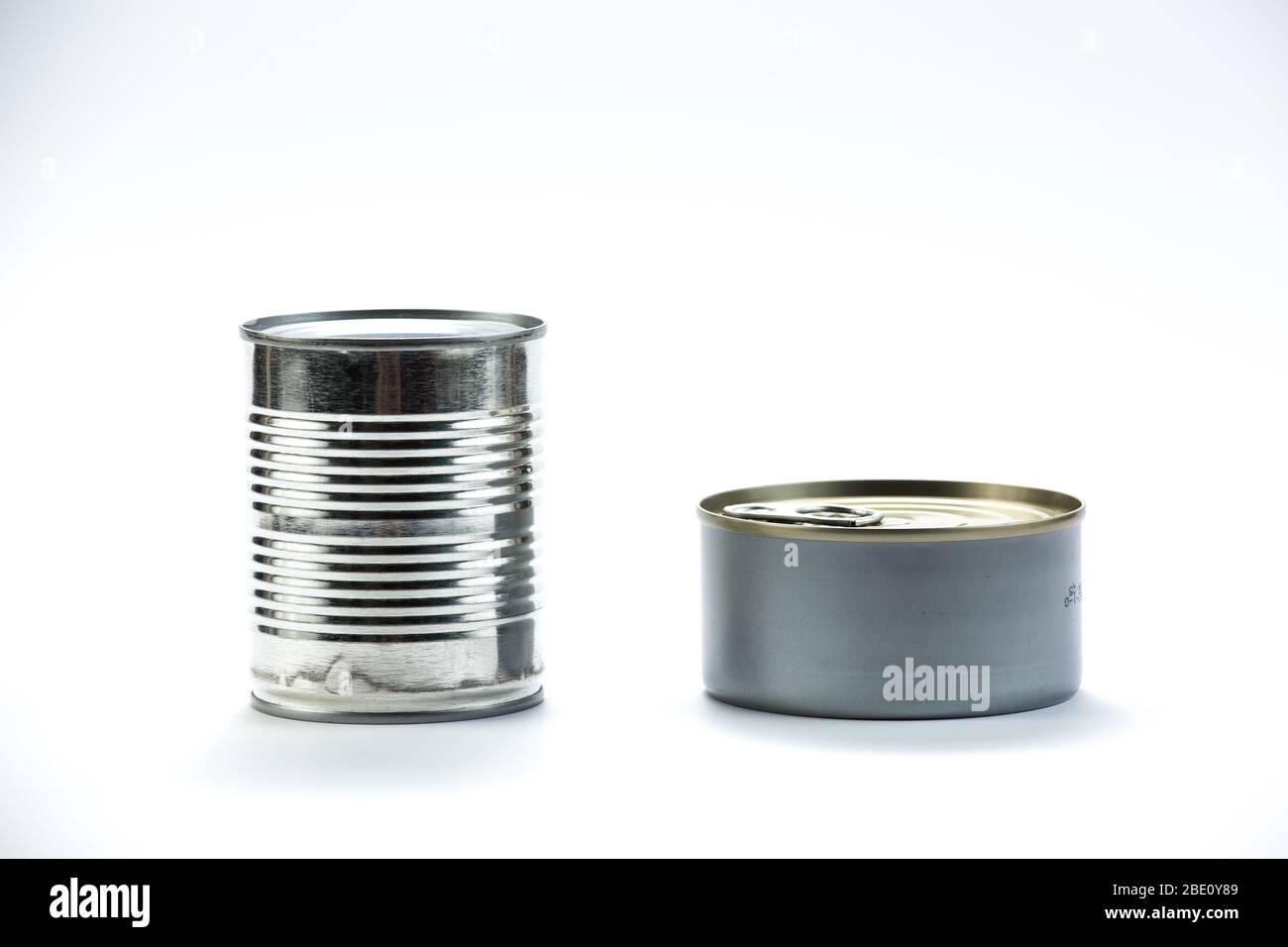 Pile of cans of conserved food over white background Stock Photo - Alamy