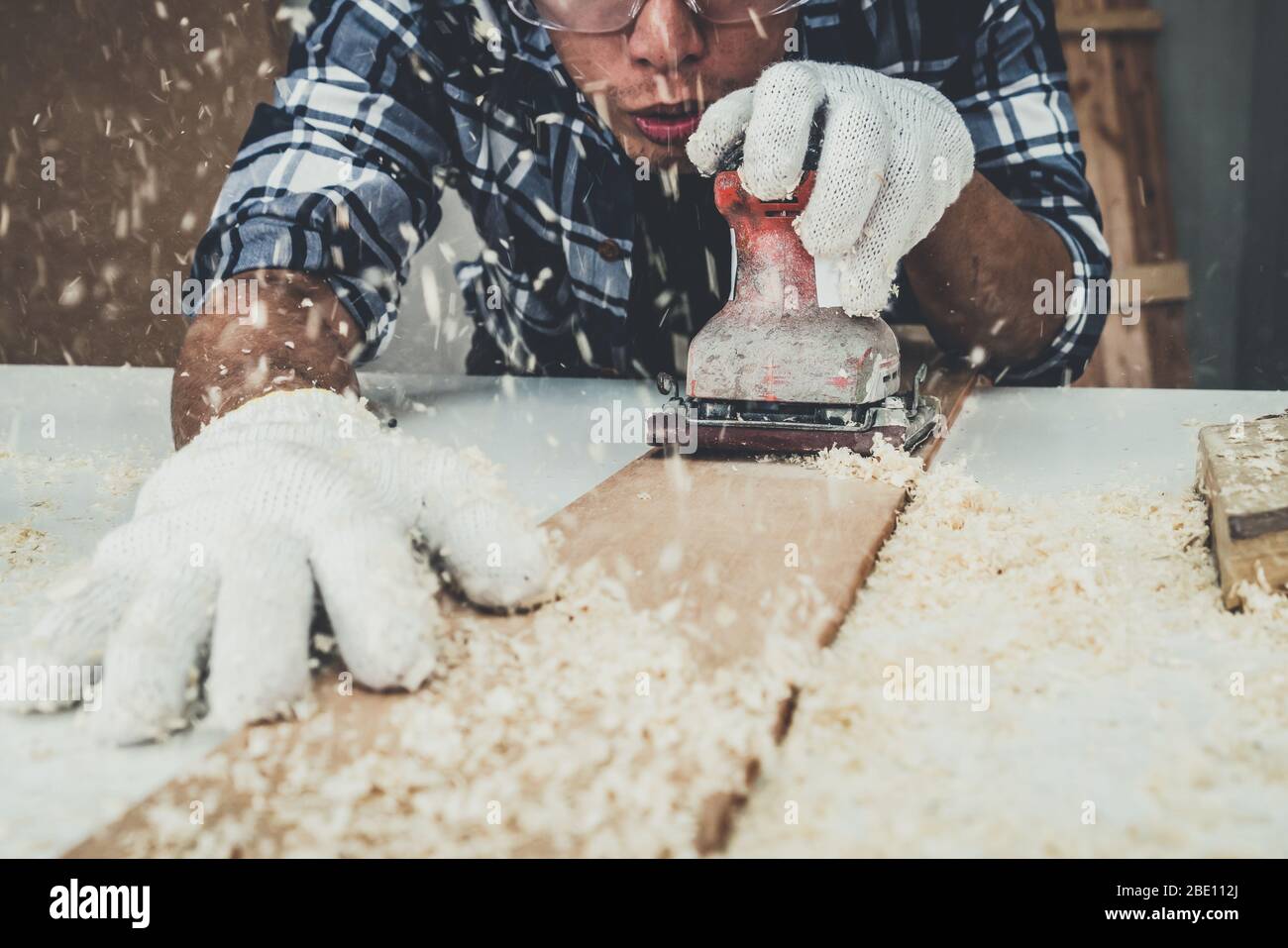 Carpenter working on wood craft at workshop to produce construction ...