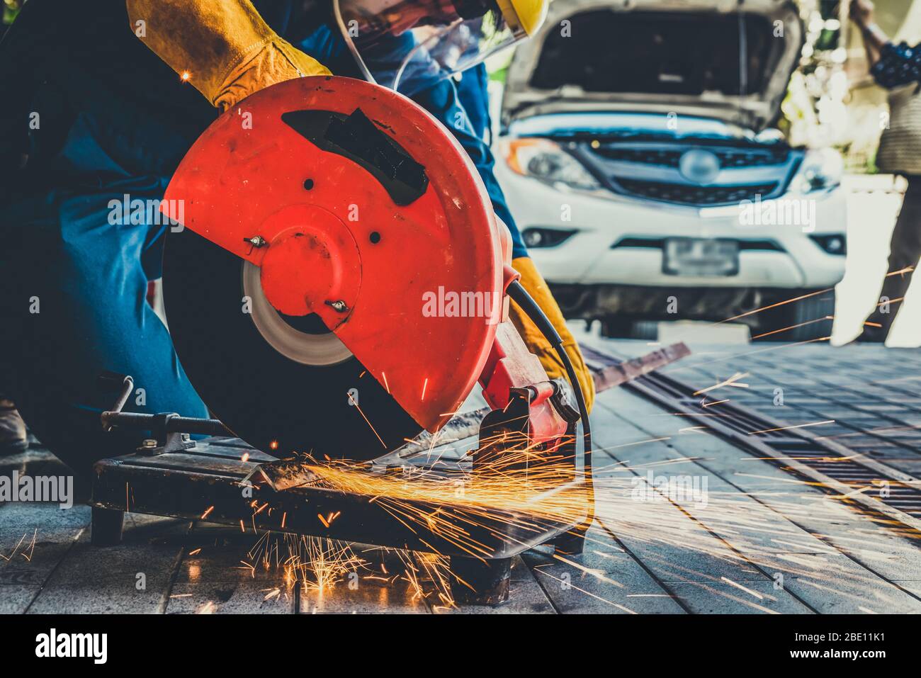 Professional mechanic is cutting steel metal with rotating diamond ...