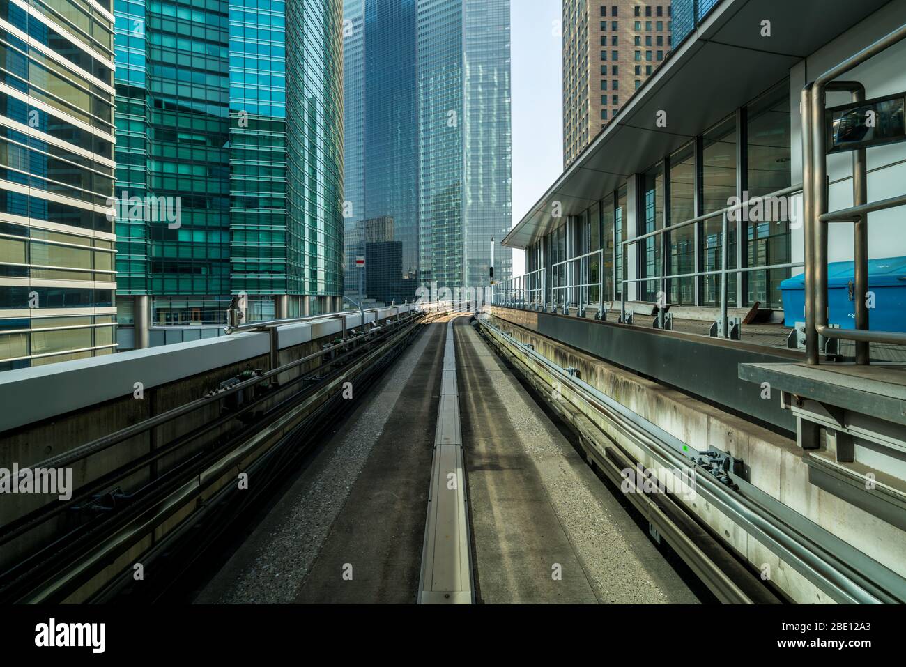 Front view of train in modern city. Straight rail with city buildings ...