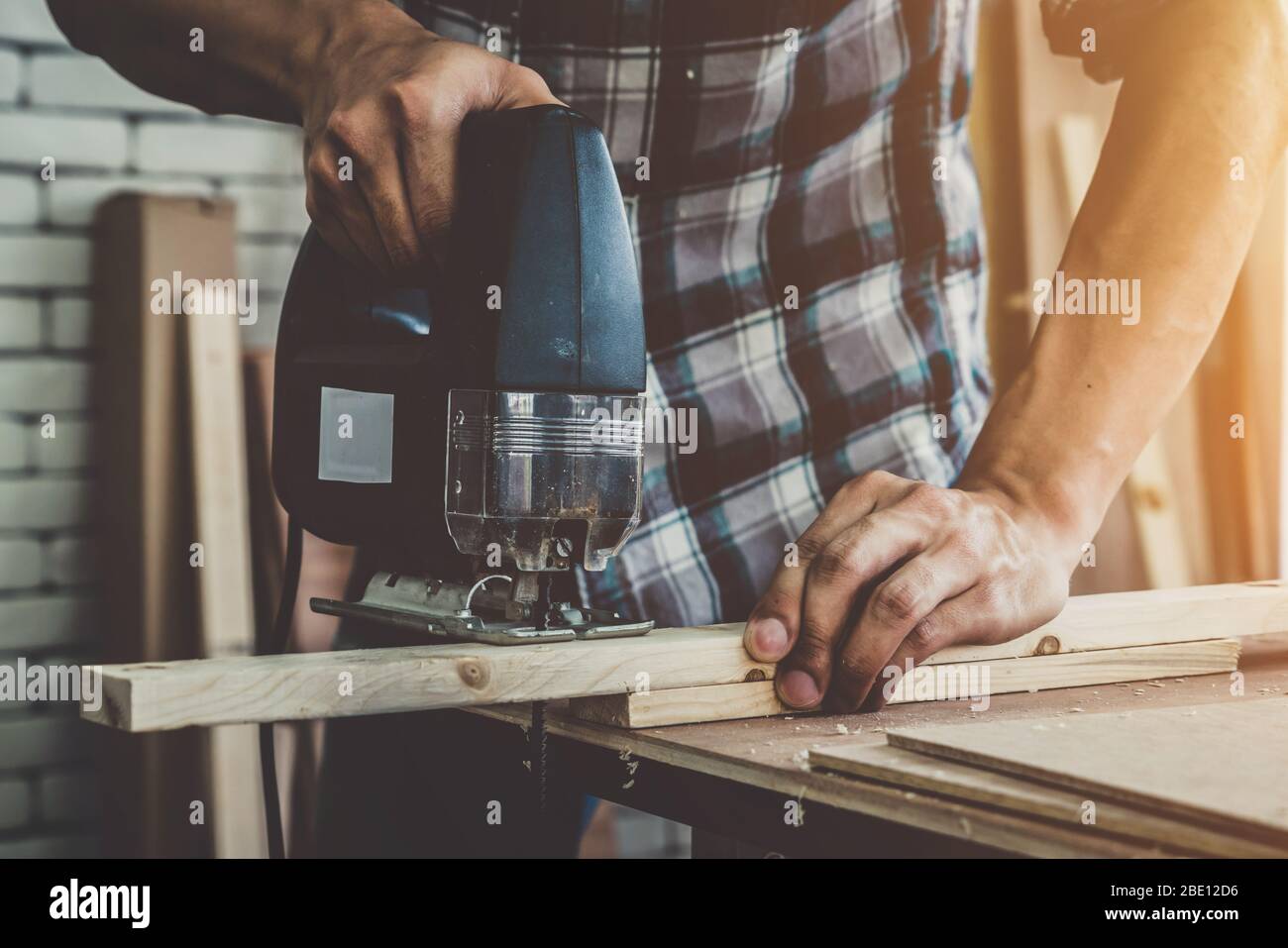 Carpenter working on wood craft at workshop to produce construction ...