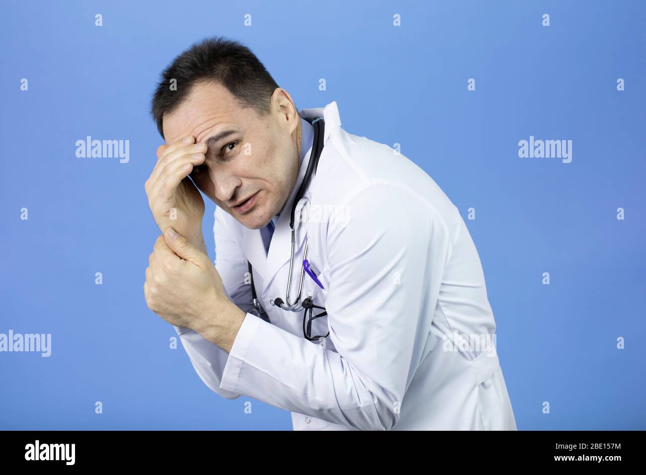 Handsome doctor hiding with hand on forehead, shocked with shame face ...