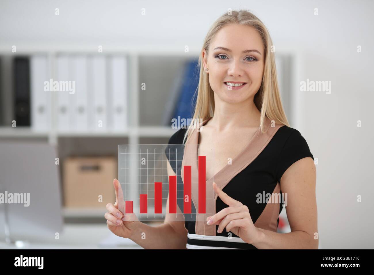 Blonde woman holding a chart in hands Stock Photo - Alamy