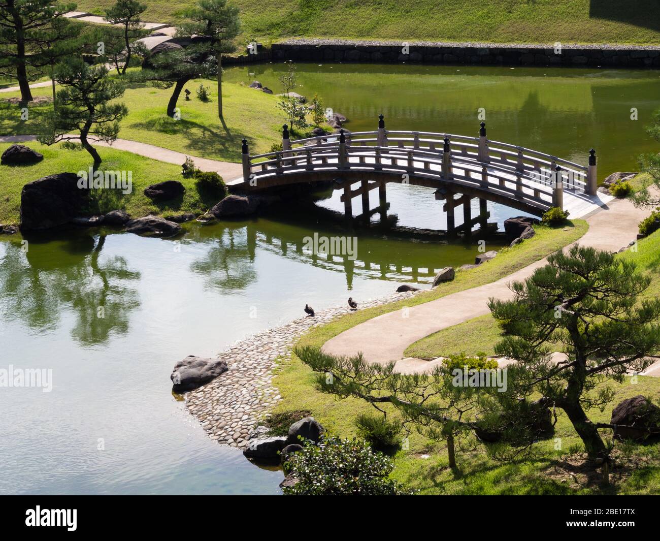 Traditional Japanese garden with pond and wooden arched bridge Stock ...