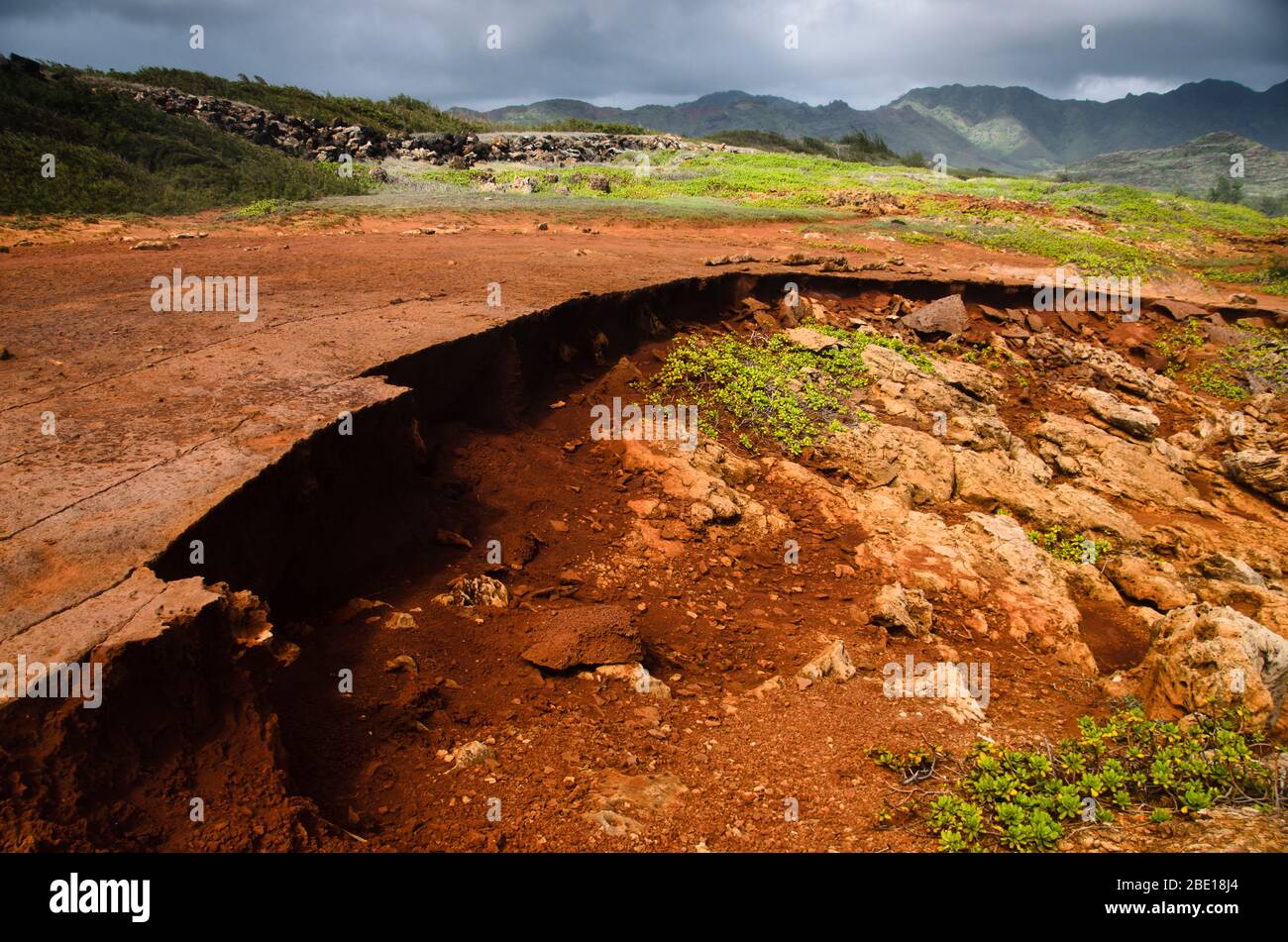 Hawaiian landscape with red crumbling soil Stock Photo - Alamy