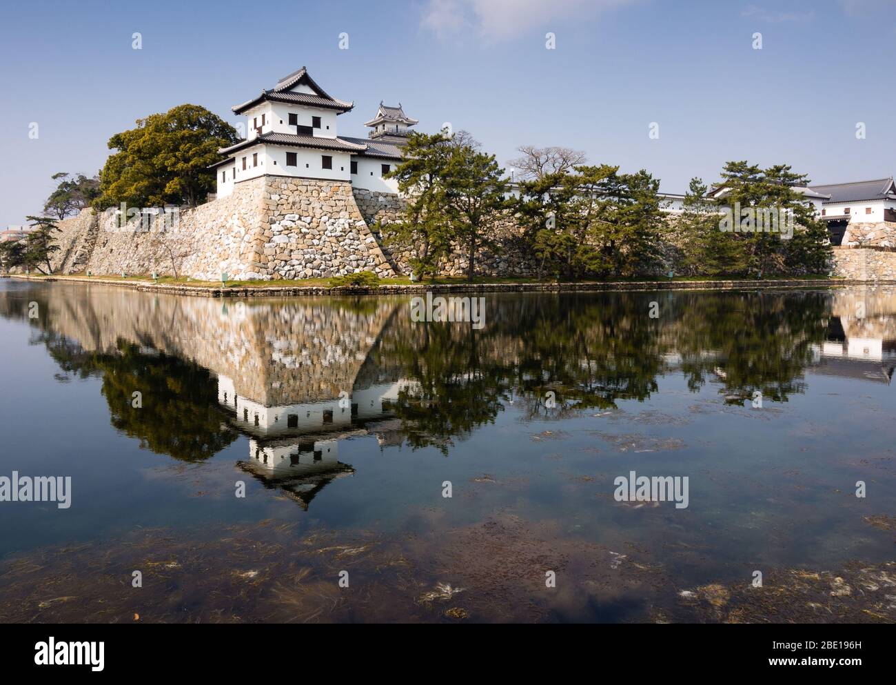 Traditional Japanese samurai castle reflected in water in Imabari ...