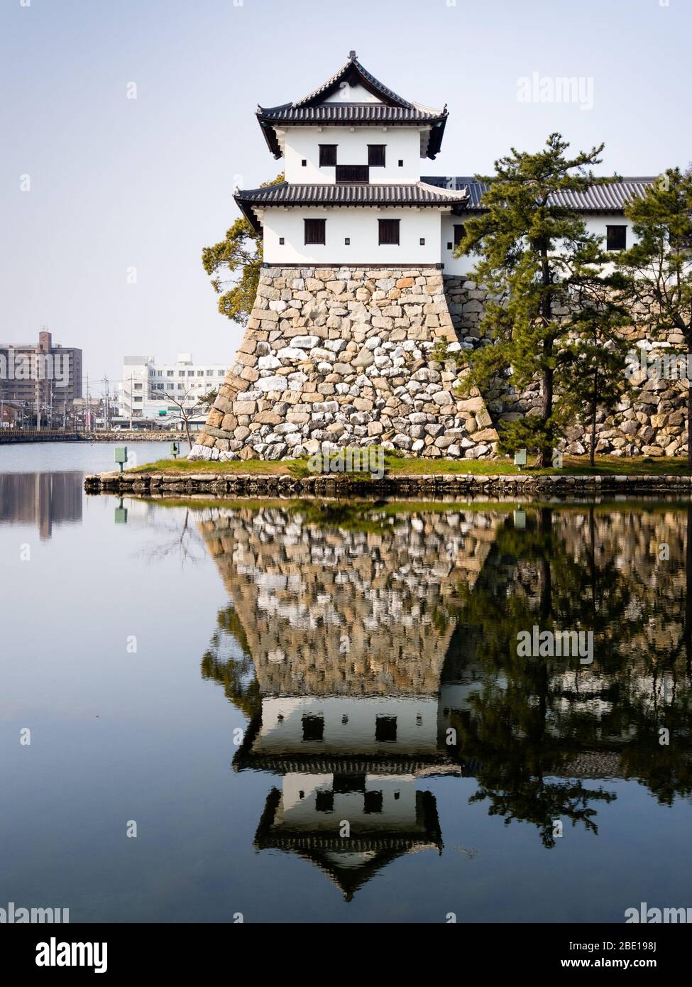 Turret of traditional Japanese samurai castle reflected in water - in ...