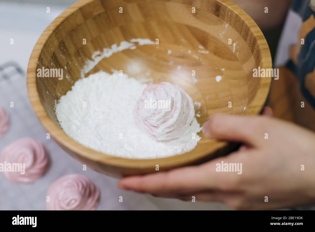 Homemade pink marshmallows on baking paper background on the kitchen ...