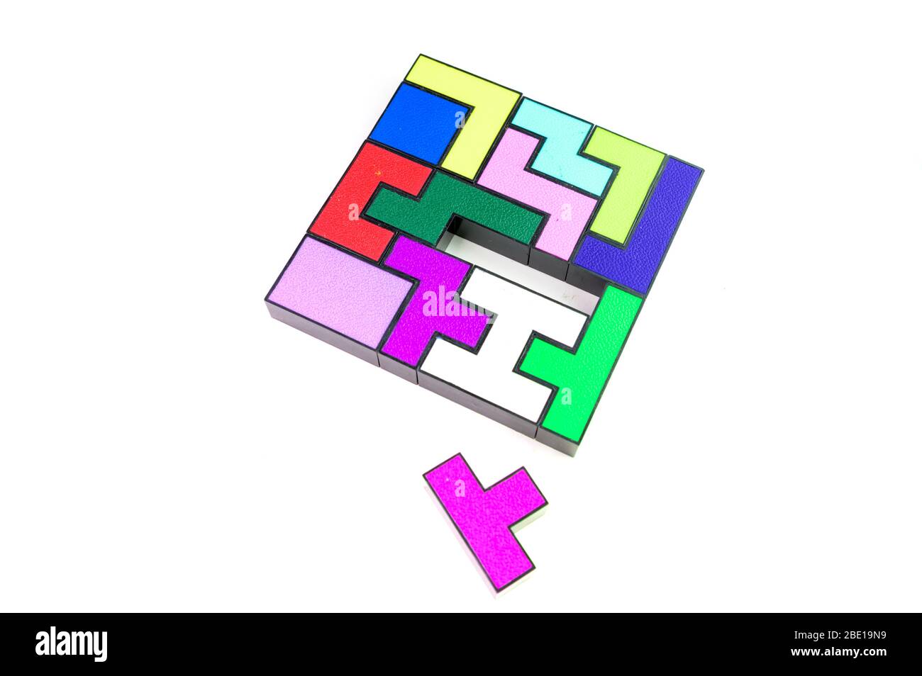 Multi-colored puzzle made of plastic blocks, that's missing a piece ...