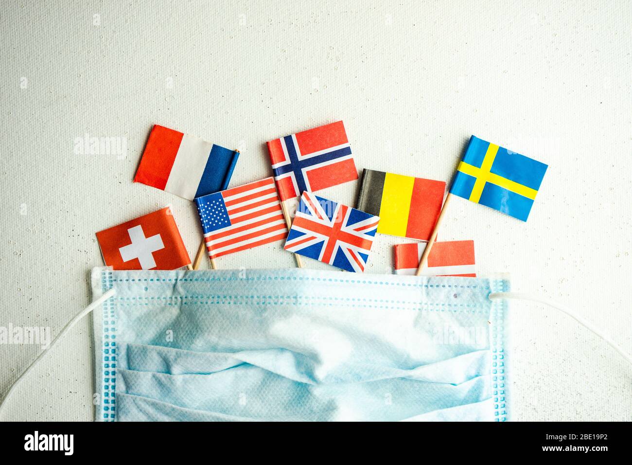 The flags of many countries protected with face mask as a COVID-19 ...