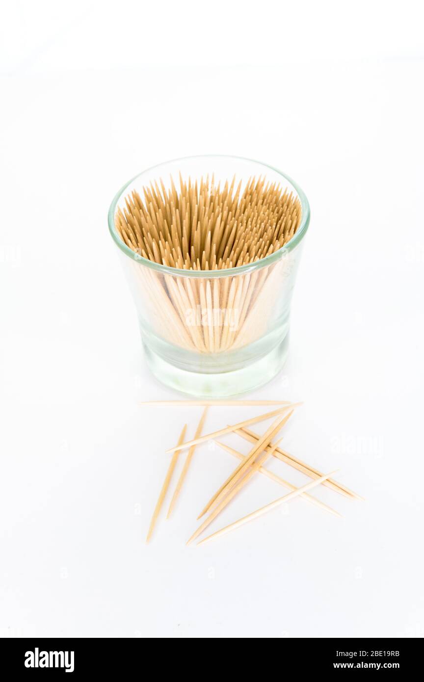 A small glass filled with many toothpicks, isolated on a white ...