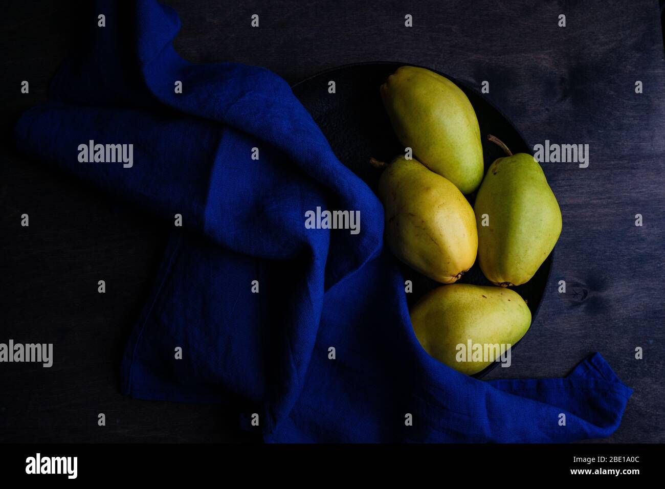 Ripe raw pear fruits in a bowl on vintage table with copy space Stock ...
