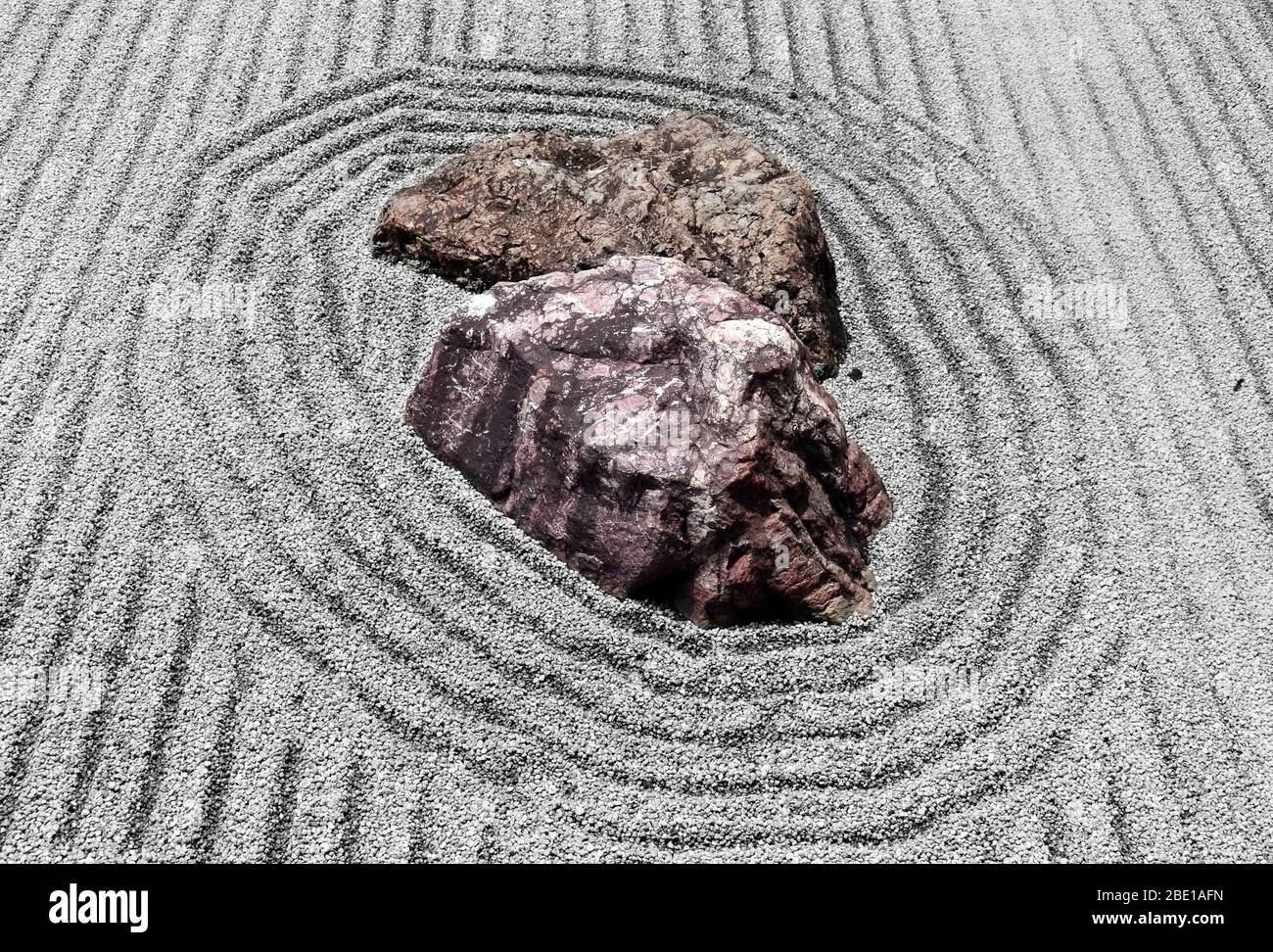 Two rocks in a Japanese rock garden Stock Photo - Alamy