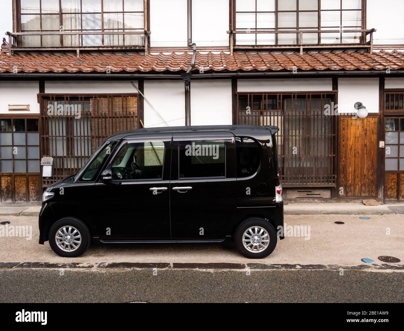 Small modern car parked in front of traditional Japanese house Stock ...