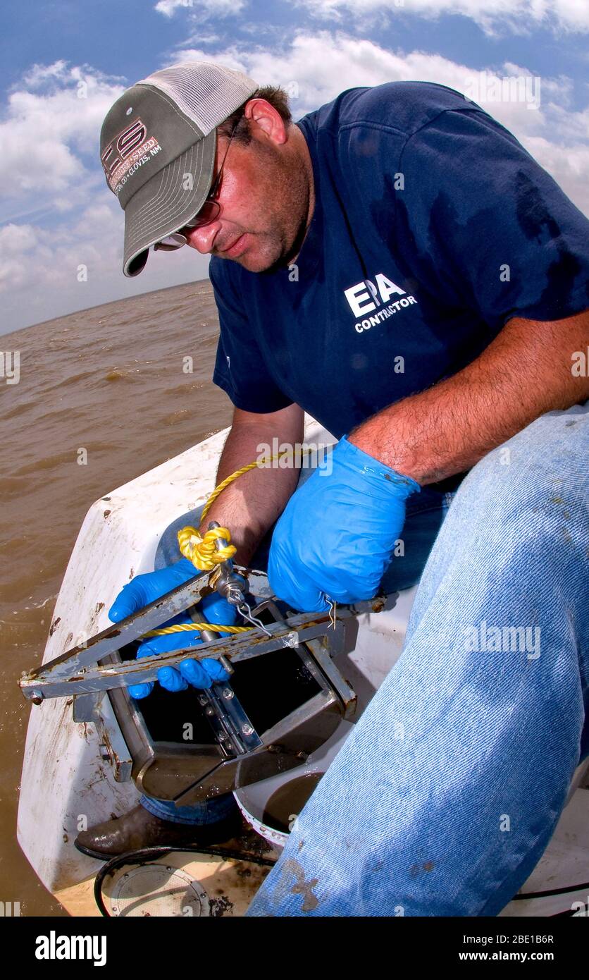 An EPA contractor taking sediment samples in the Gulf of Mexico during ...