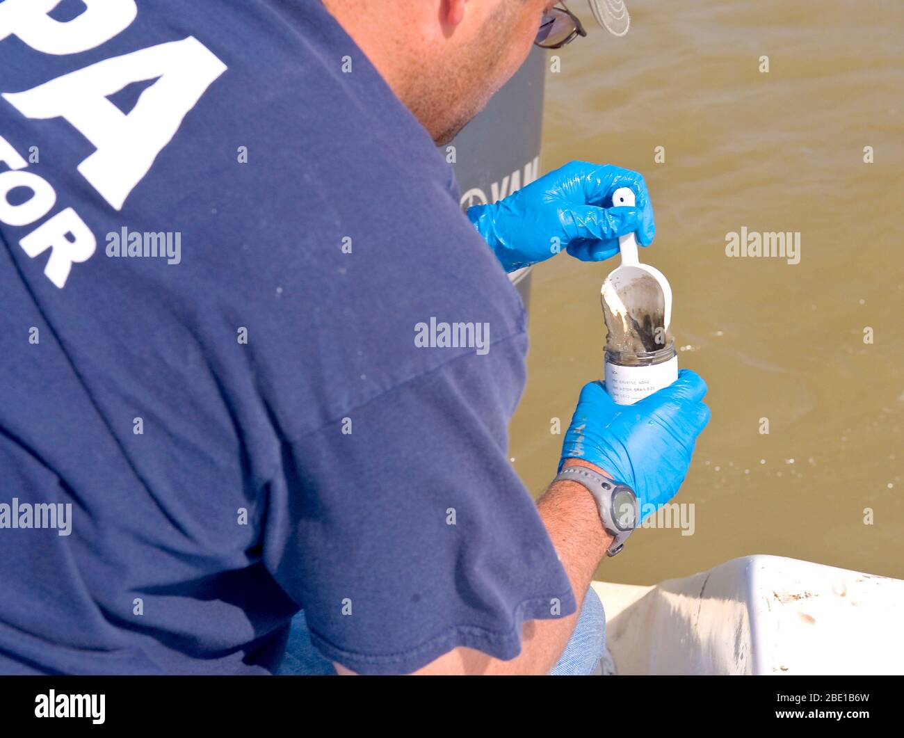 An EPA contractor taking sediment samples in the Gulf of Mexico during ...