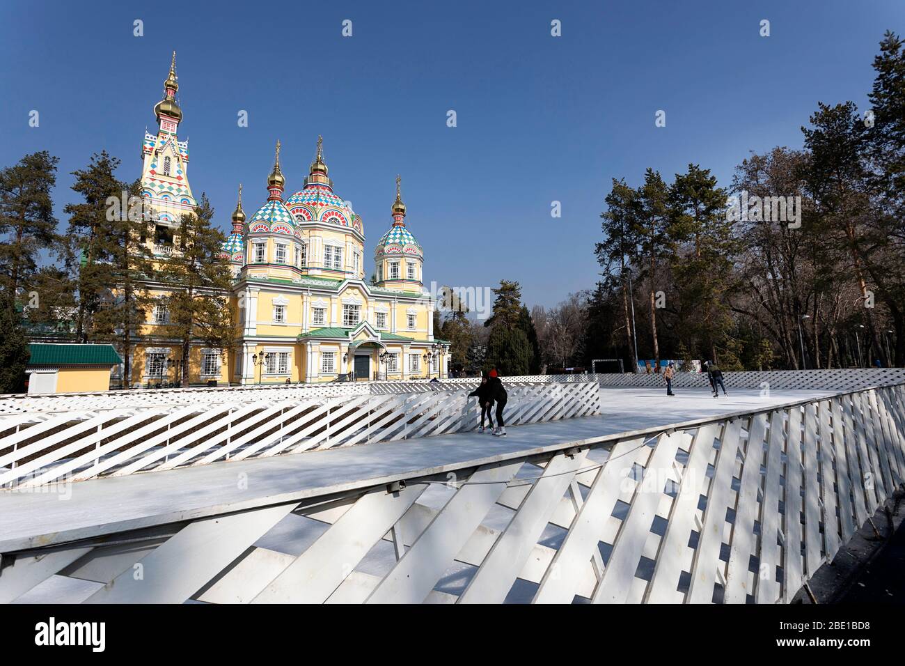 People ice skating on the iIce rink in front of Ascension Cathedral ...