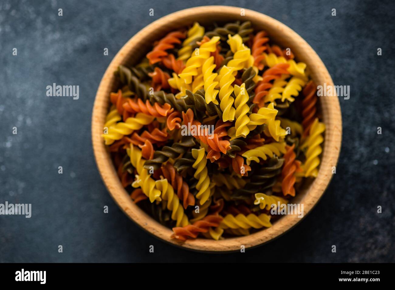Italian food concept with wooden bowl full of fusilli bucati pasta on ...