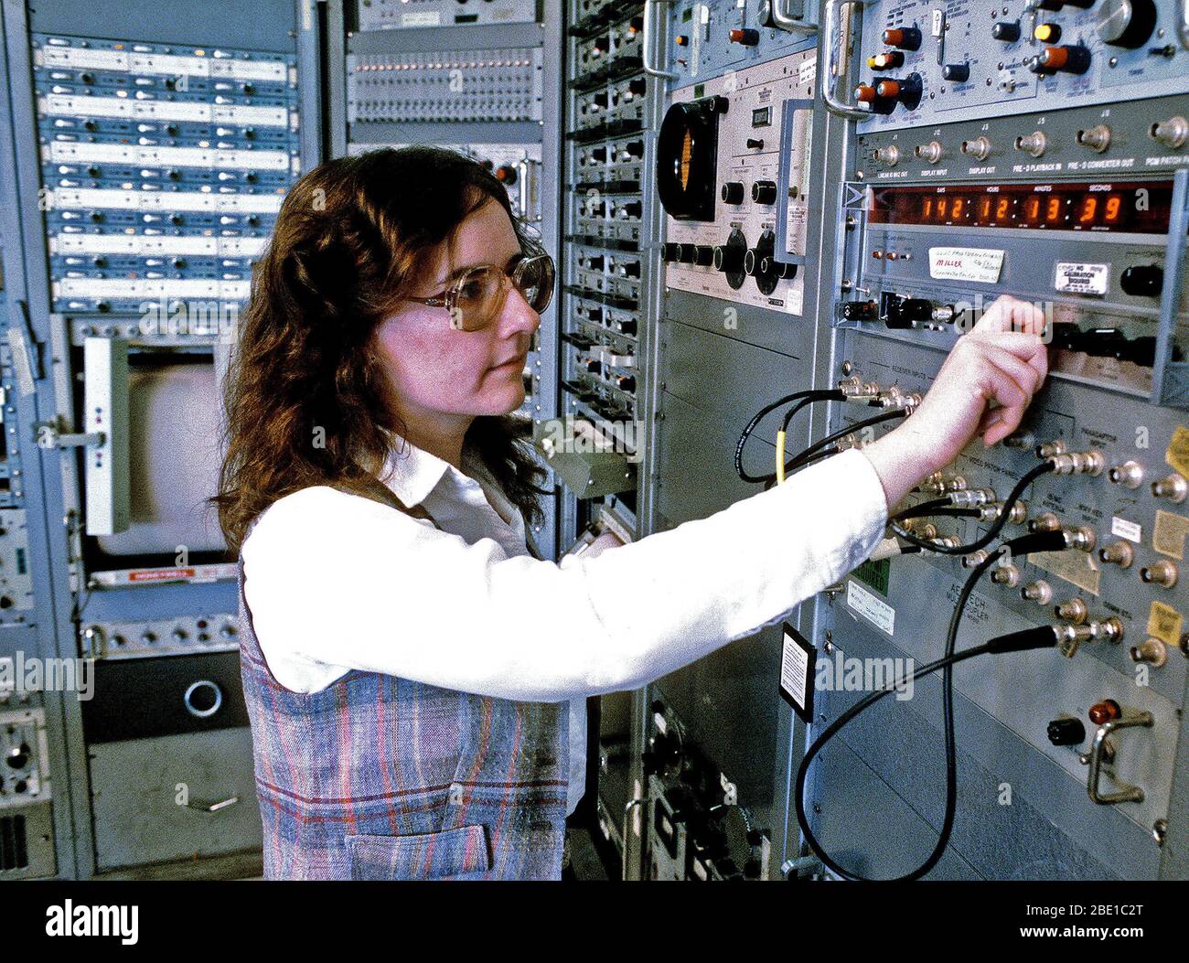 A computer engineer inputs data into a computer panel in the telemetry ...