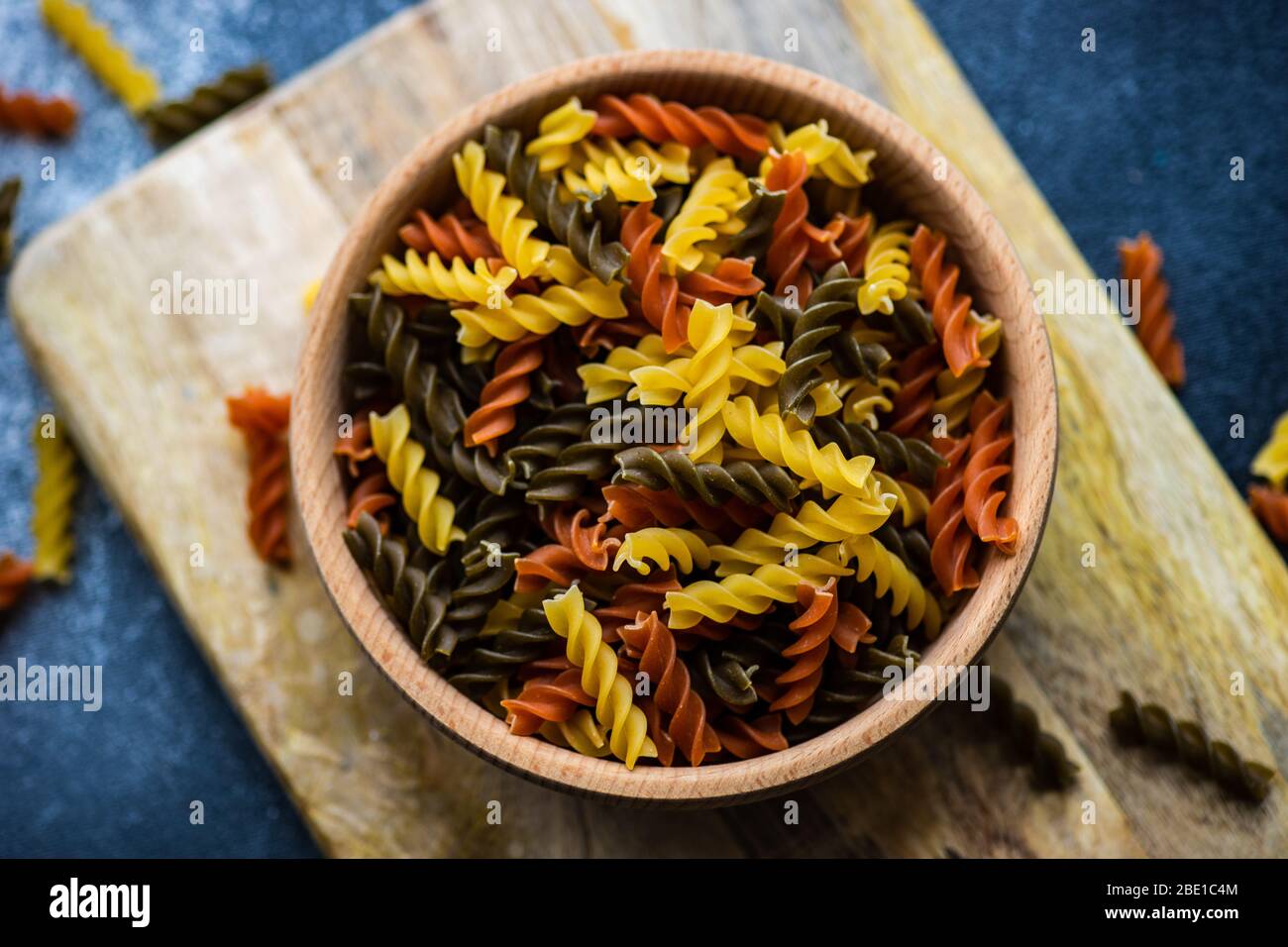 Italian food concept with wooden bowl full of fusilli bucati pasta on ...