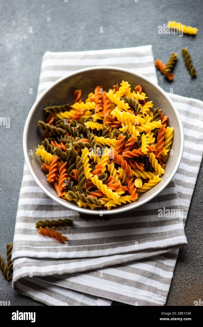 Italian food concept with wooden bowl full of fusilli bucati pasta on ...