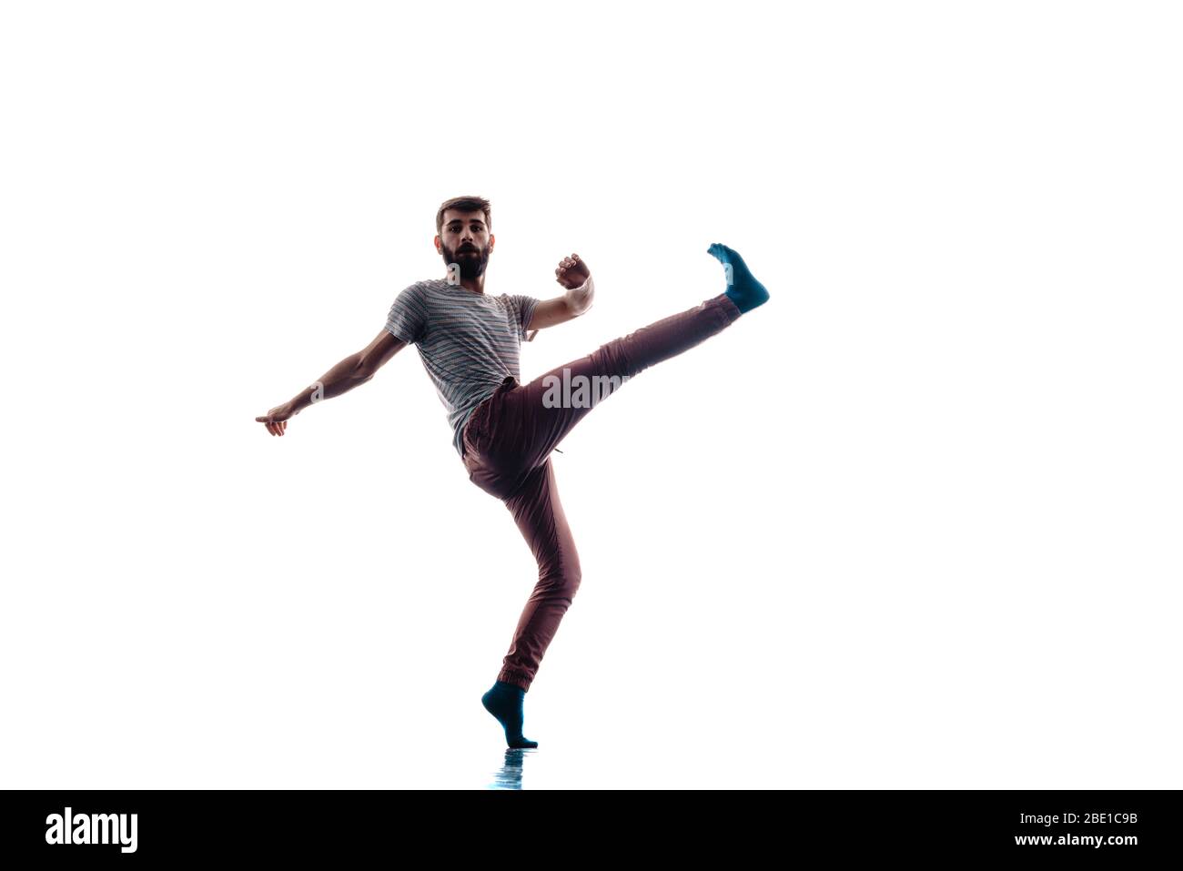 Muscular young guy practicing modern style dance poses Stock Photo - Alamy
