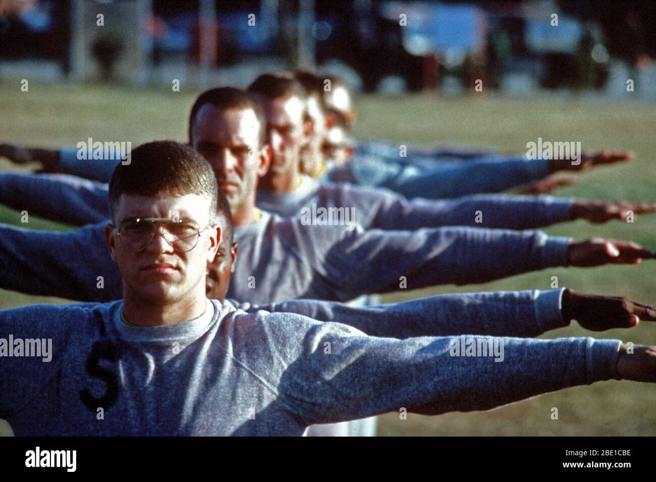 1980 - A column of Marine officer candidates prepare to do an arm ...