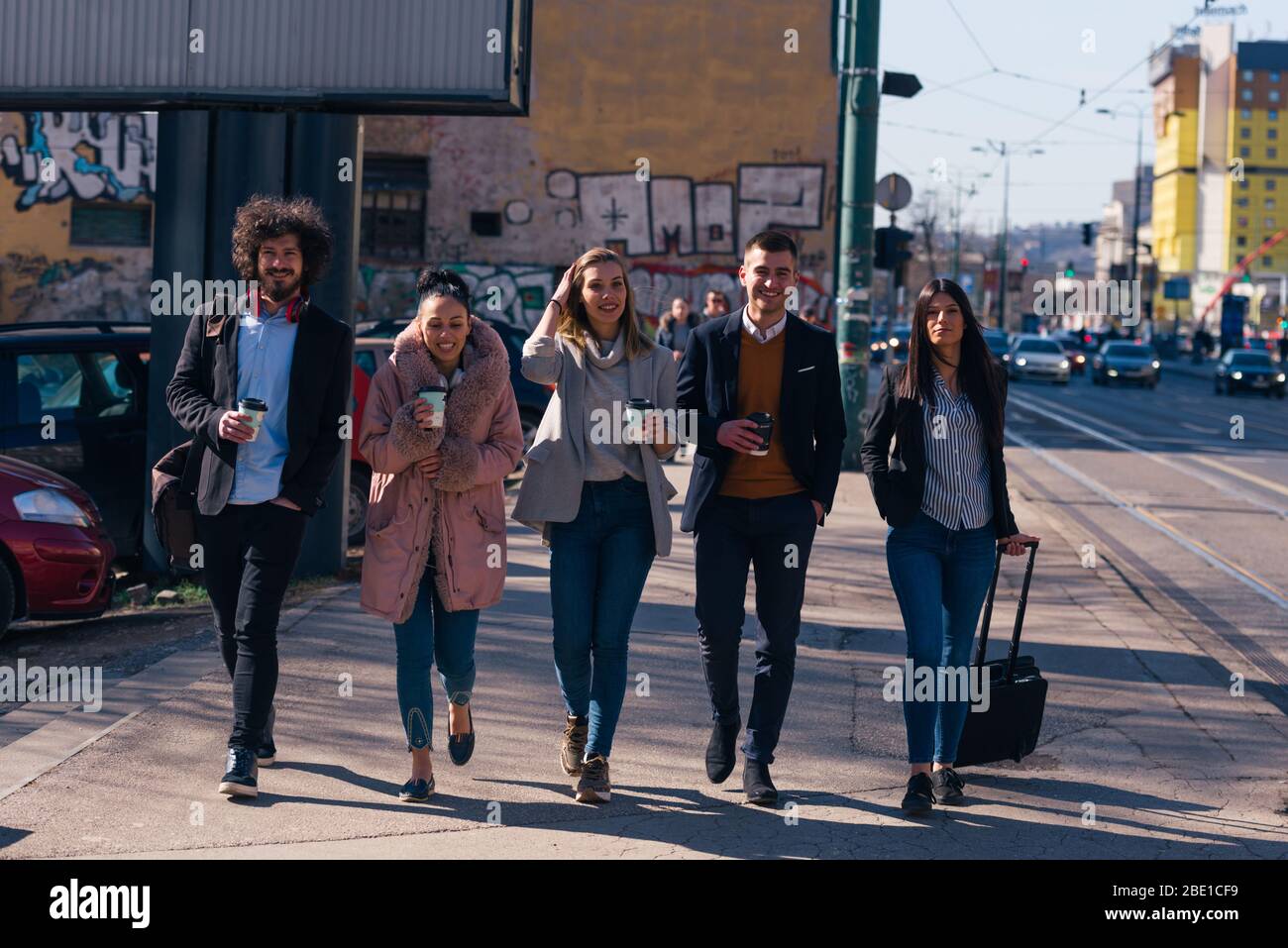 Group of friends (colleagues) hanging out in an urban area Stock Photo ...