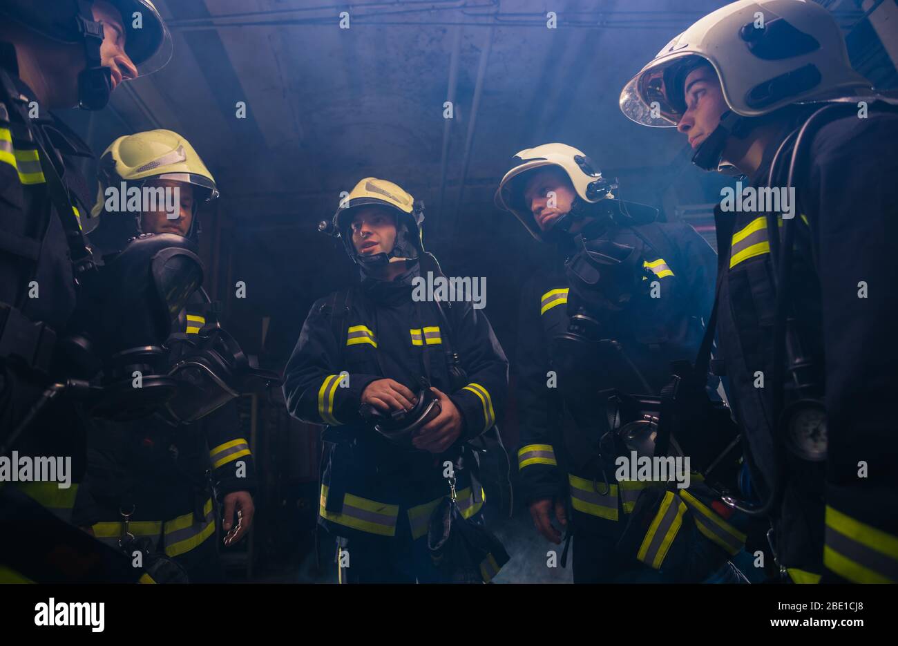Group of firemen in the fire department organizing action plan for safe ...