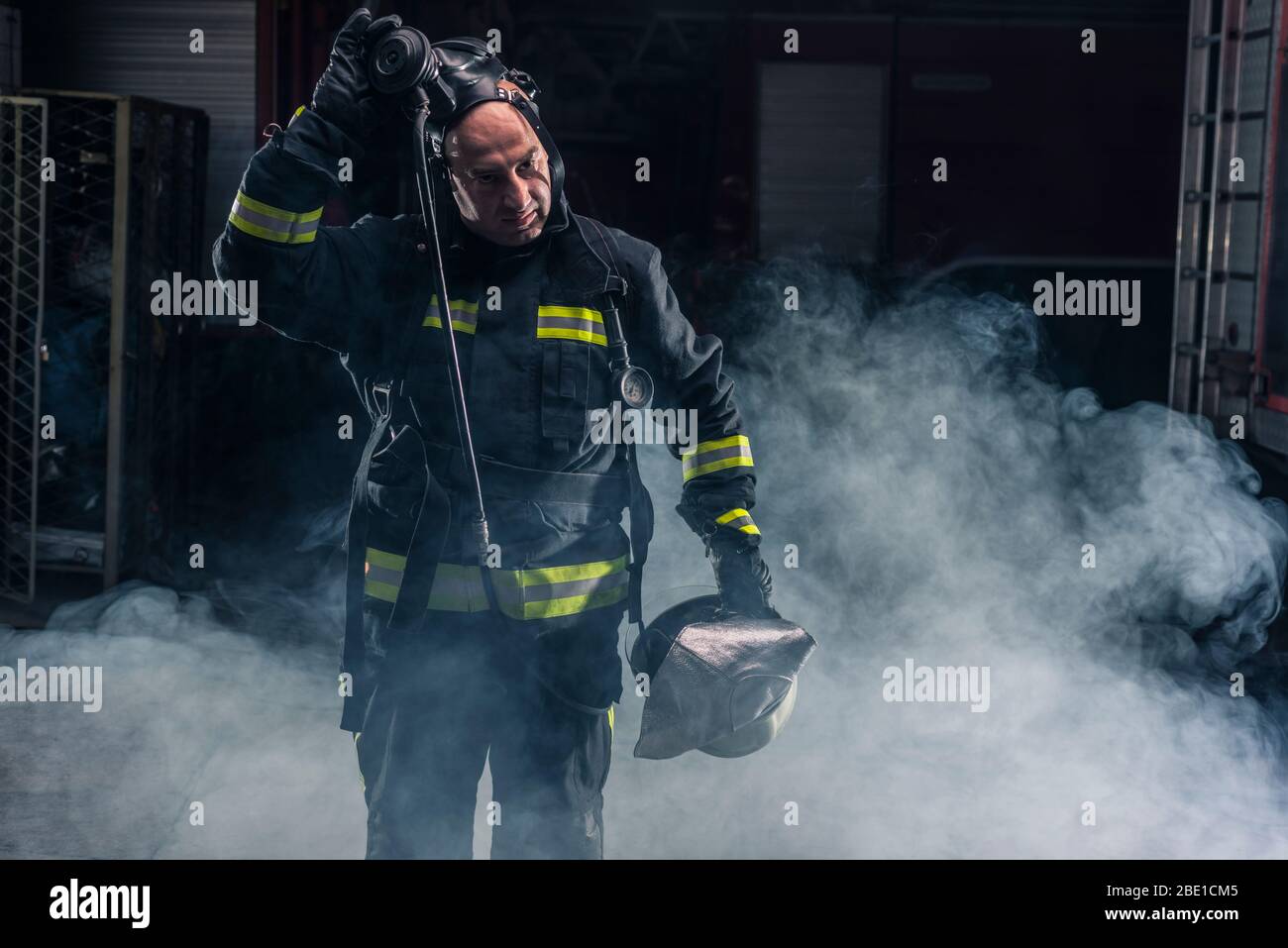 Fireman standing confident holding helmet and wearing firefighter ...