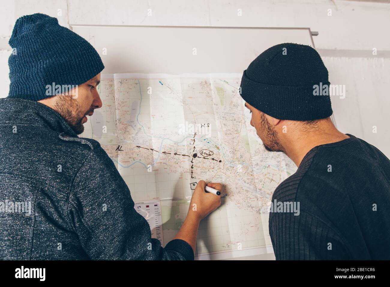 Stealers are drawing a plan for crime on the map in basement Stock ...