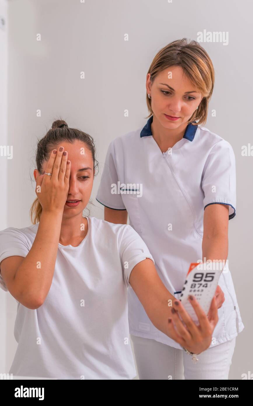 Woman ( girl )reviewing eyesight closing eye with hand. Eye test ... Woman ( girl )reviewing eyesight closing eye with hand. Eye test ...