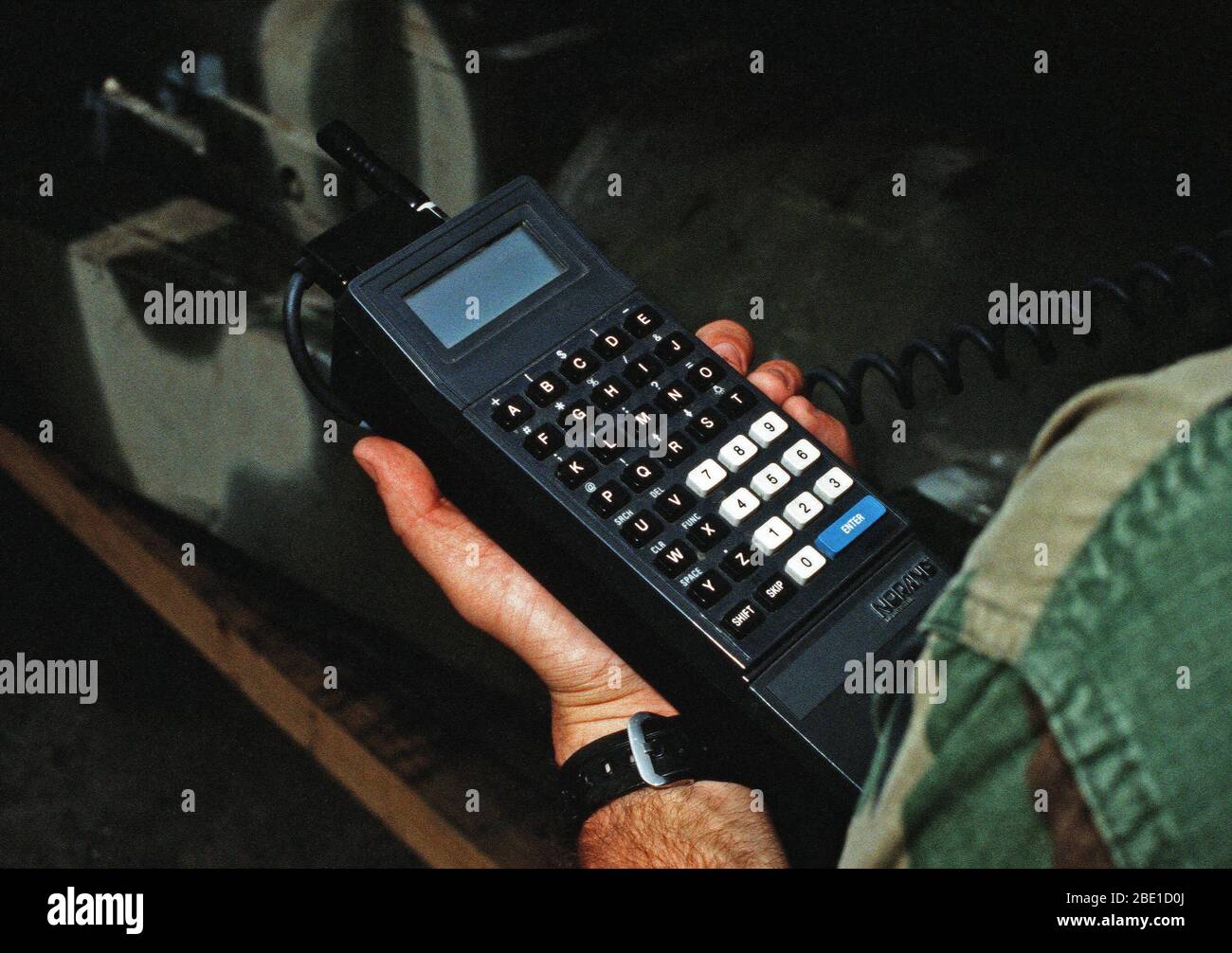 A Marine holds a small computer that he is using to take inventory of ...