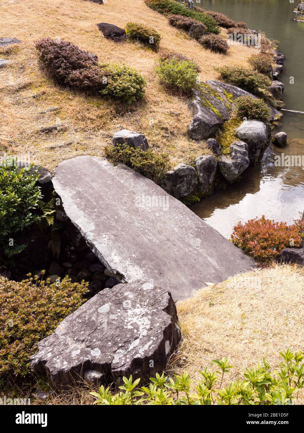 Stone bridge in a Japanese landscape garden Stock Photo - Alamy