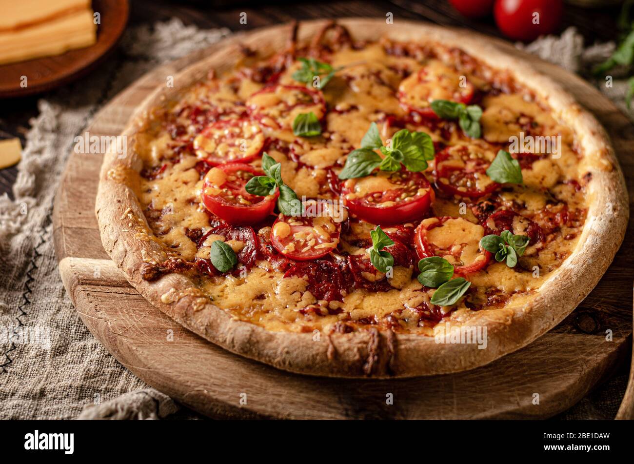 Rustic homemade pizza with sharp cheddar chesse and spicy salami Stock ...