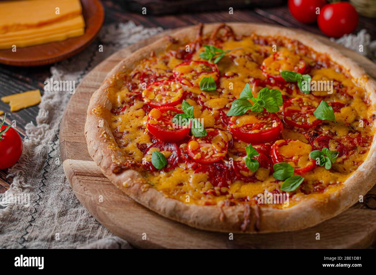 Rustic homemade pizza with sharp cheddar chesse and spicy salami Stock ...