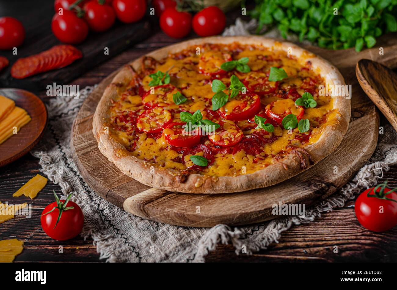 Rustic homemade pizza with sharp cheddar chesse and spicy salami Stock ...