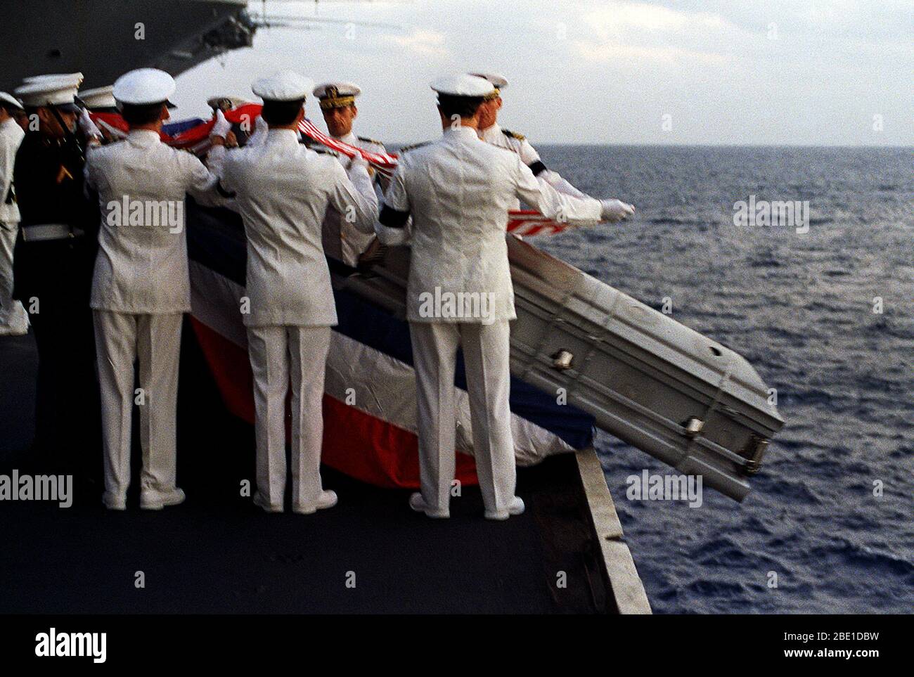 1982 - The coffin of a fallen Marine slides into the sea during a ...