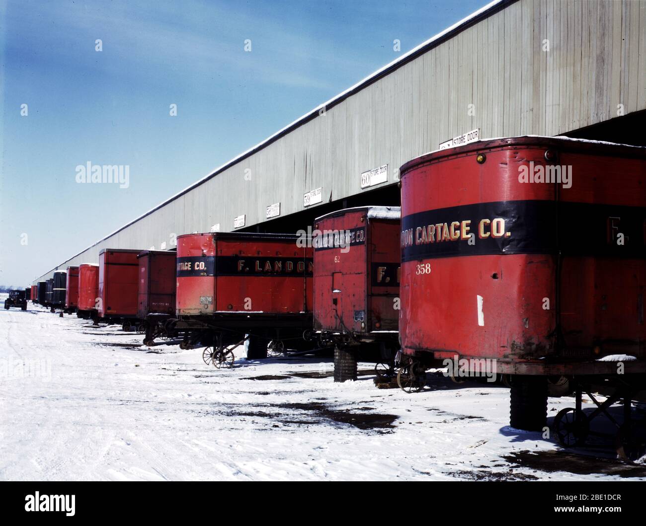 Truck trailers line up at a freight house to load and unload goods from ...