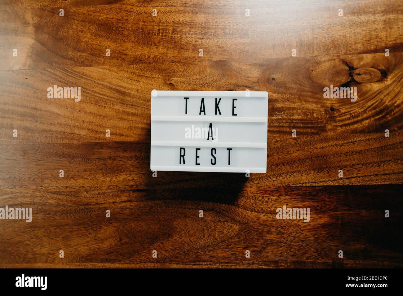 'Take a rest' text in light box on wooden background Stock Photo - Alamy