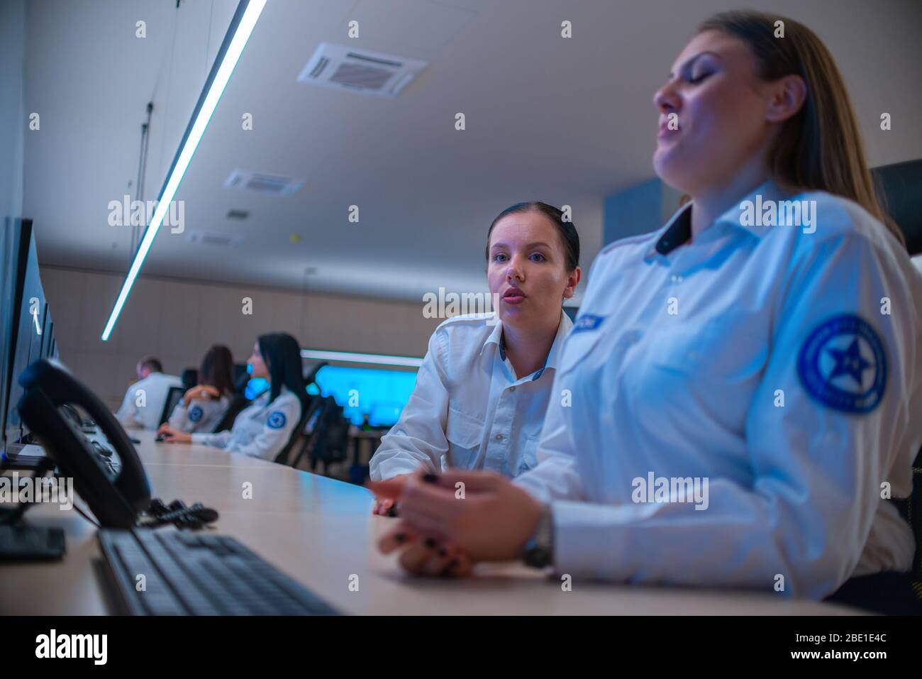 Close up photo of a security female agent monitoring the CCTV in a main ...