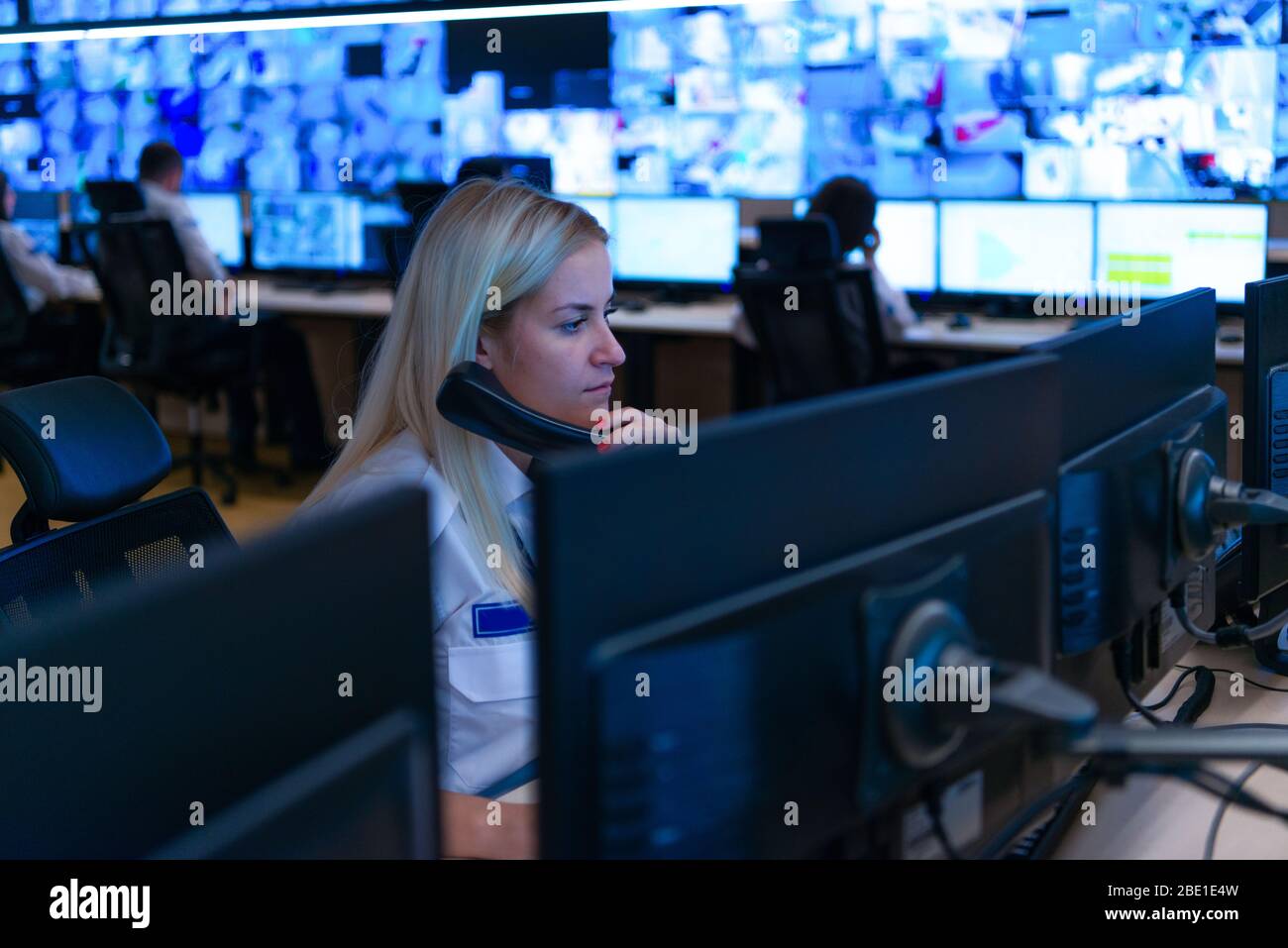 Technical Operator Works at His Workstation with Multiple Displays ...