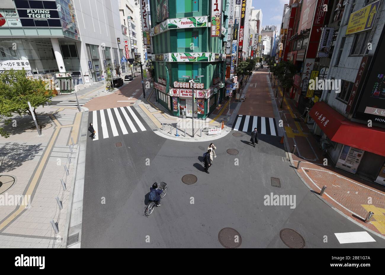 Few people are seen in Tokyo's Shinjuku area on April 11, 2020, under a ...