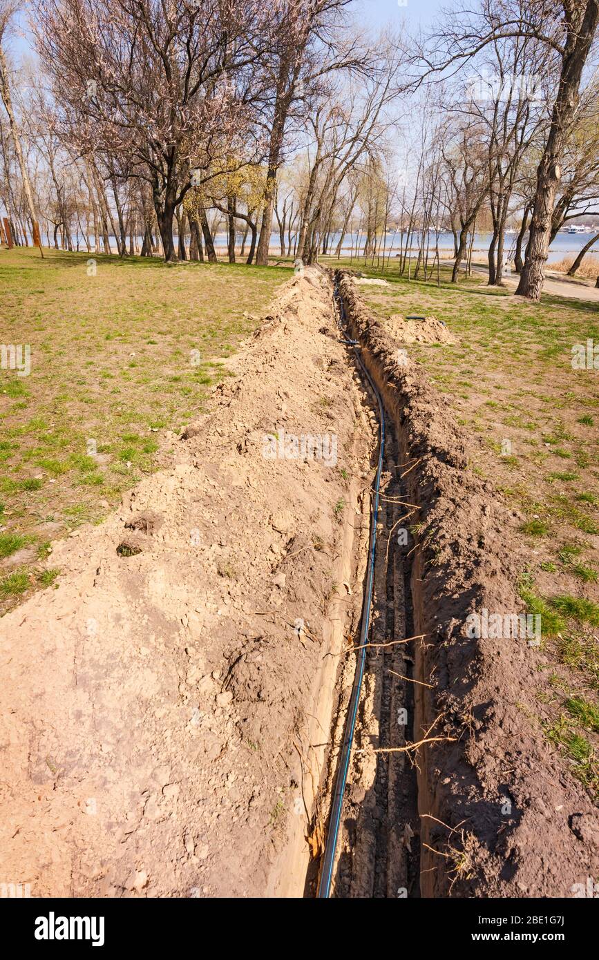 Installation of tubes for an irrigation system in the ground under the ...