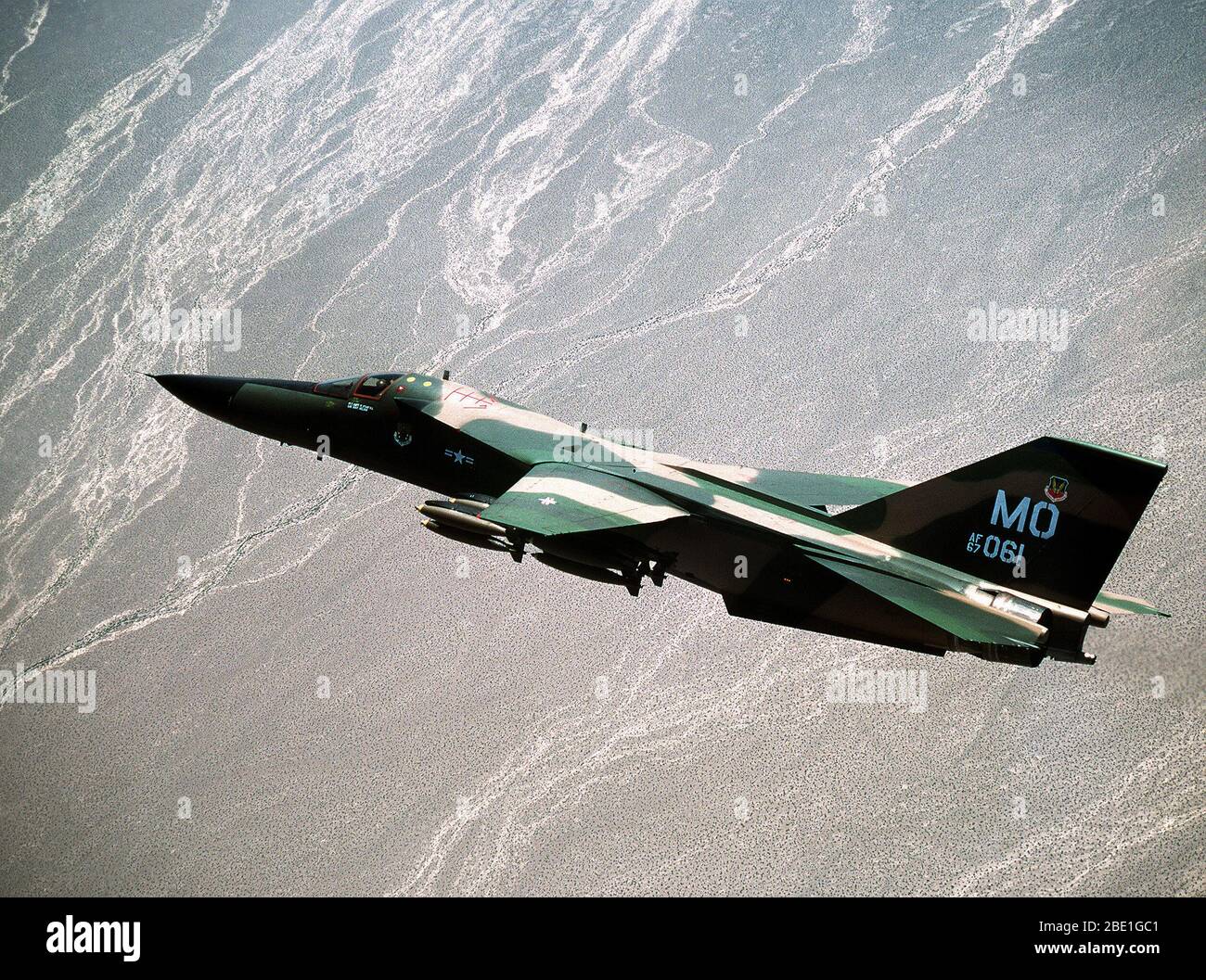 1980 - An air-to-air left side view of an F-111A aircraft banking to ...