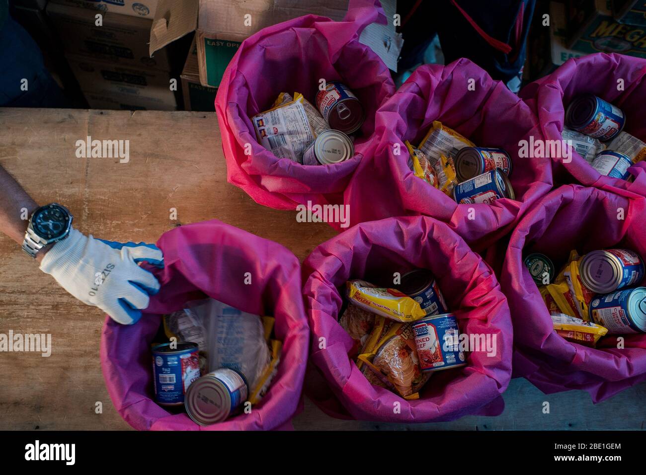 April 3, 2020 - Manila, Philippines: A volunteer worker moves a food ...